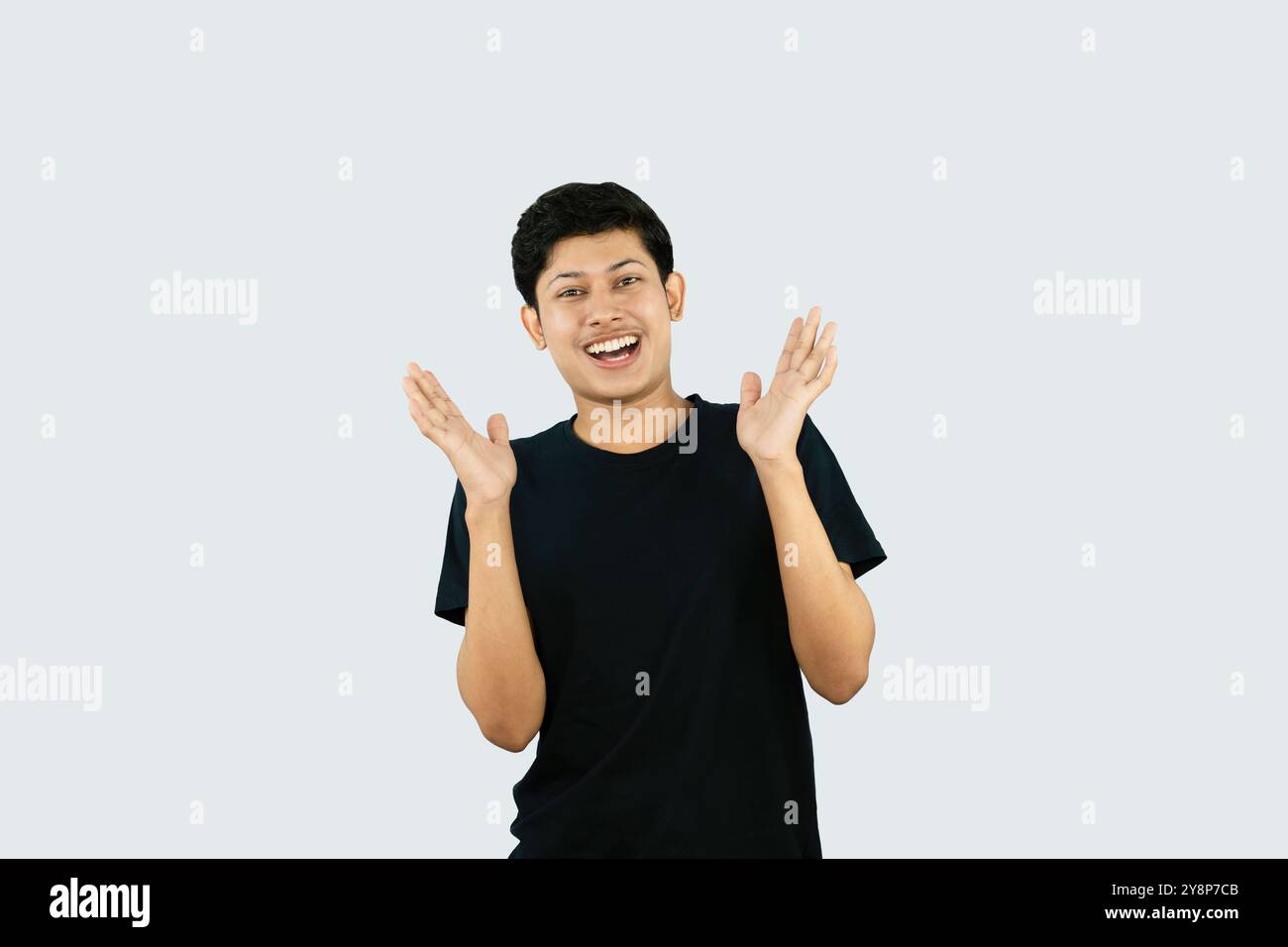 Young Asian Male boy with Black Tshirt points with finder gives ...