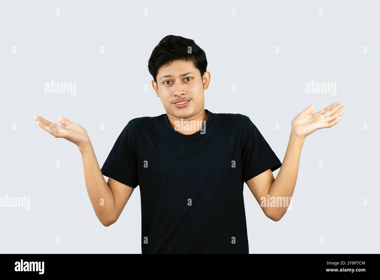 Young Asian Male boy with Black Tshirt points with finder gives ...