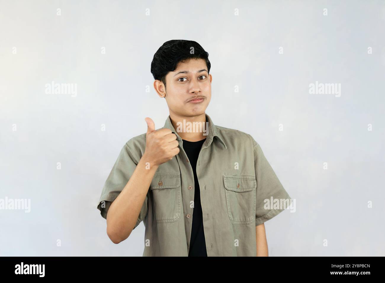 Excited Young Male gives thumbs up finger pointing expressions and ...