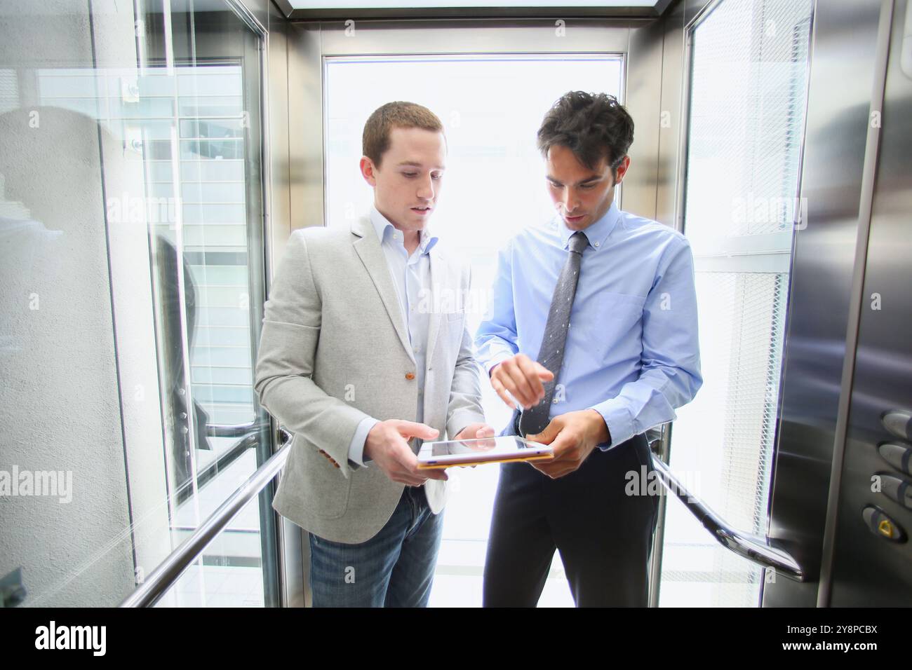 Two businesspeople in elevator hi-res stock photography and images - Alamy