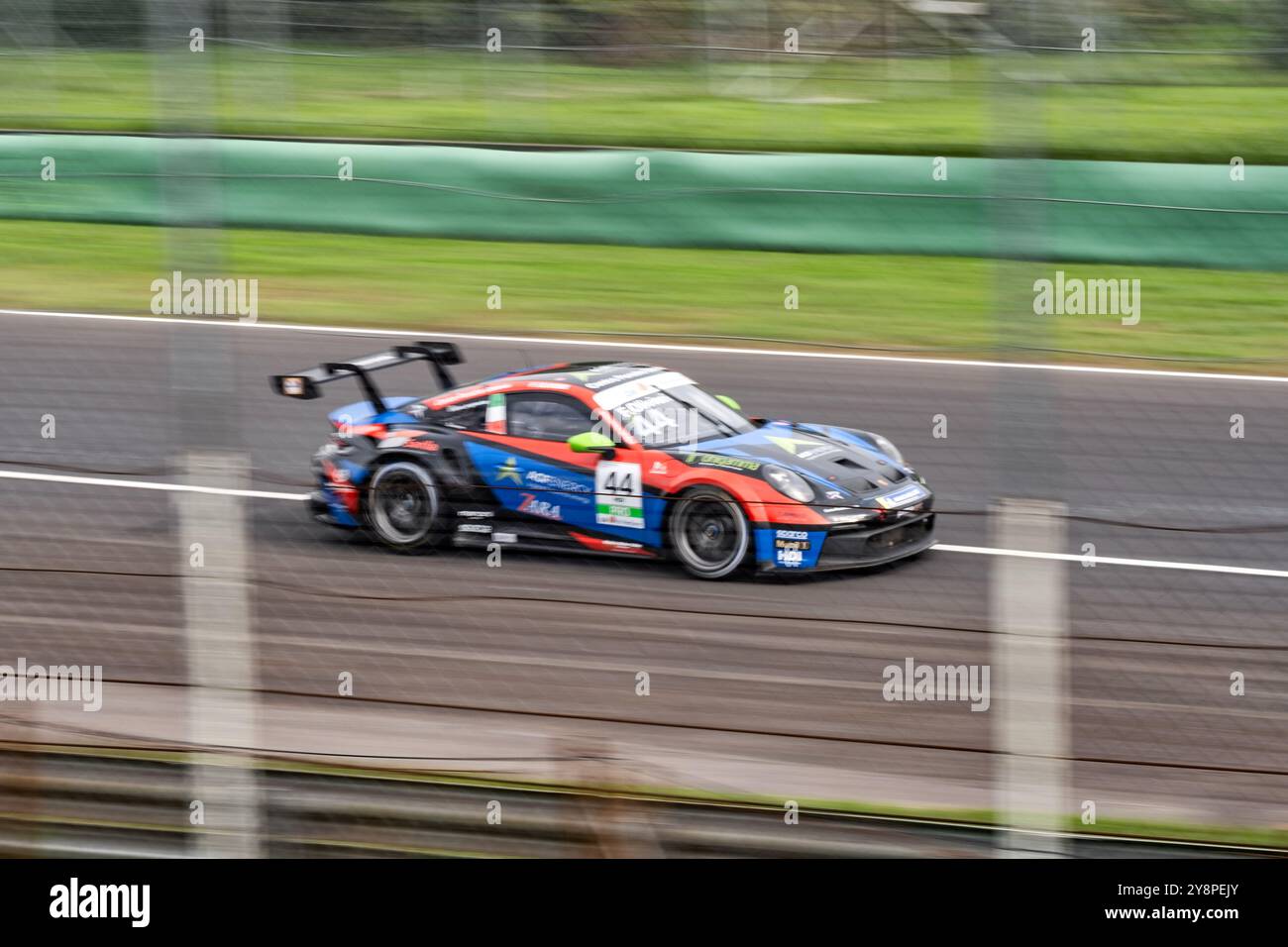 High-Speed Action at Monza Circuit: Dynamic Racing Car Captured in ...
