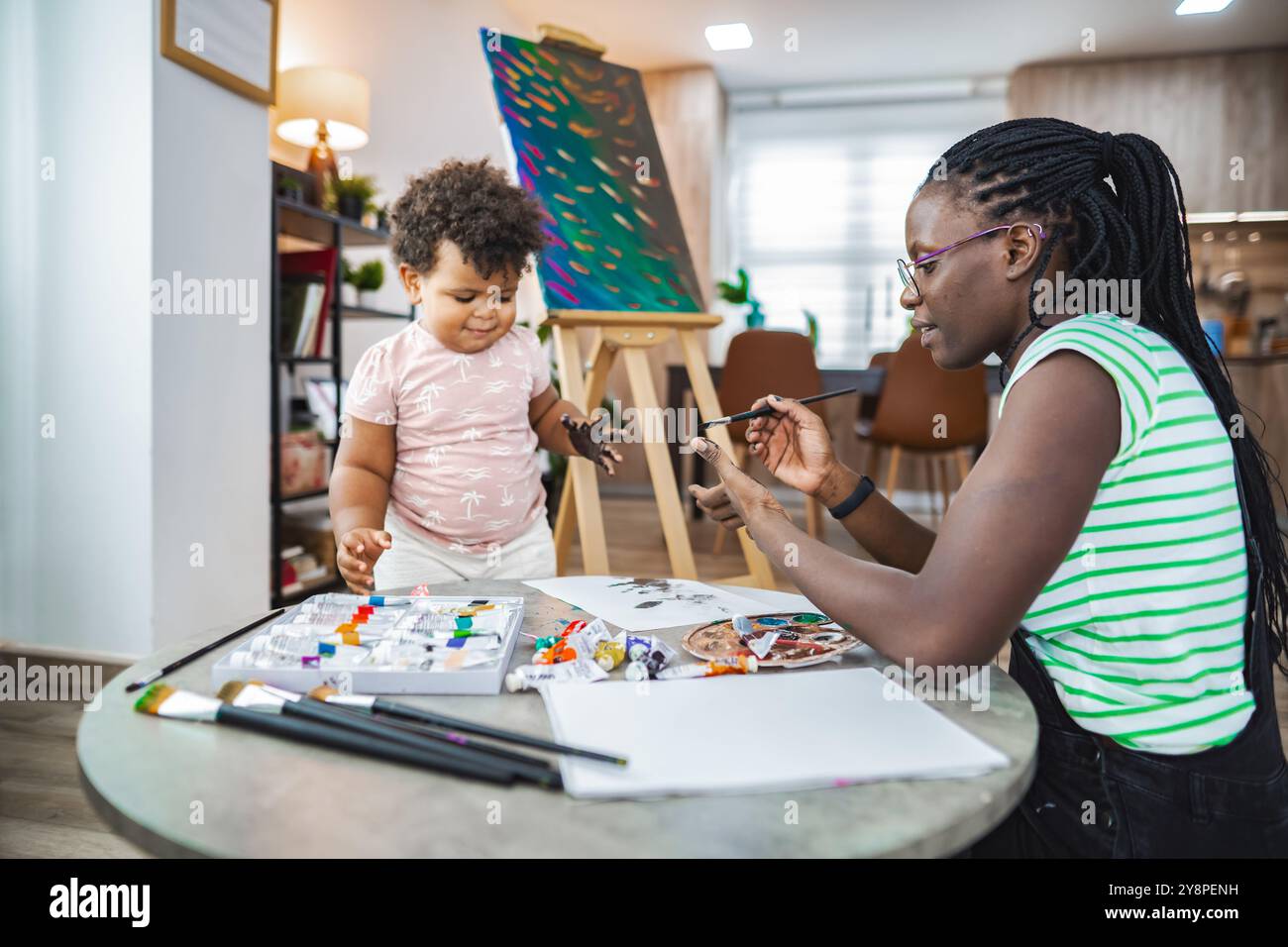 Creative bonding: A mother and child enjoy painting together Stock ...