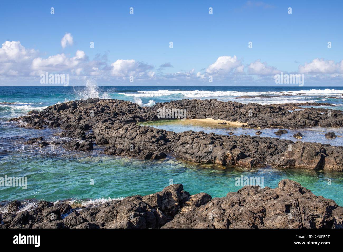 Sunrise over the sea. Sandy beach with lava rocks and beach alternate ...