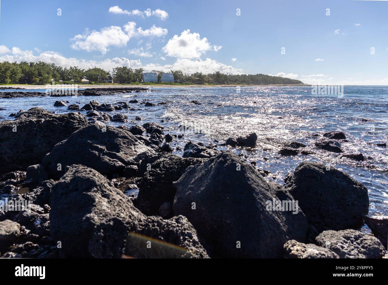 Sunrise over the sea. Sandy beach with lava rocks and beach alternate ...