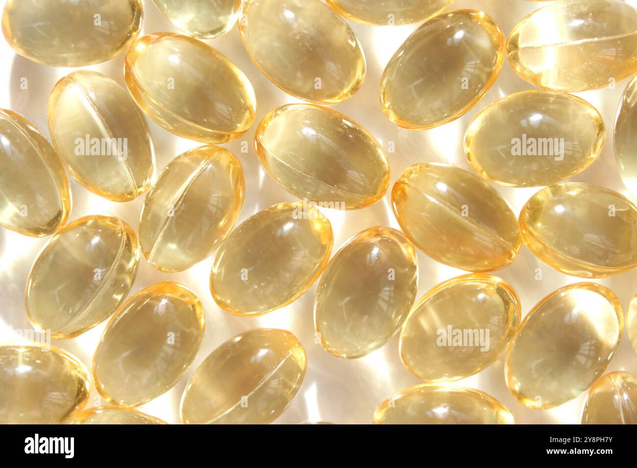 Shiny golden capsules of omega-3 fish oil rich in nutrients and health ...