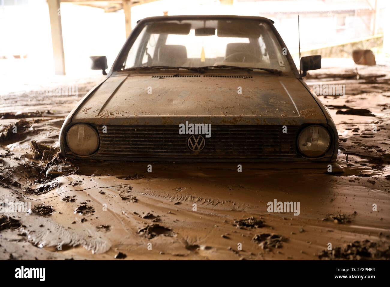 A car is submerged in mud following a flooding in Buturovic Polje ...
