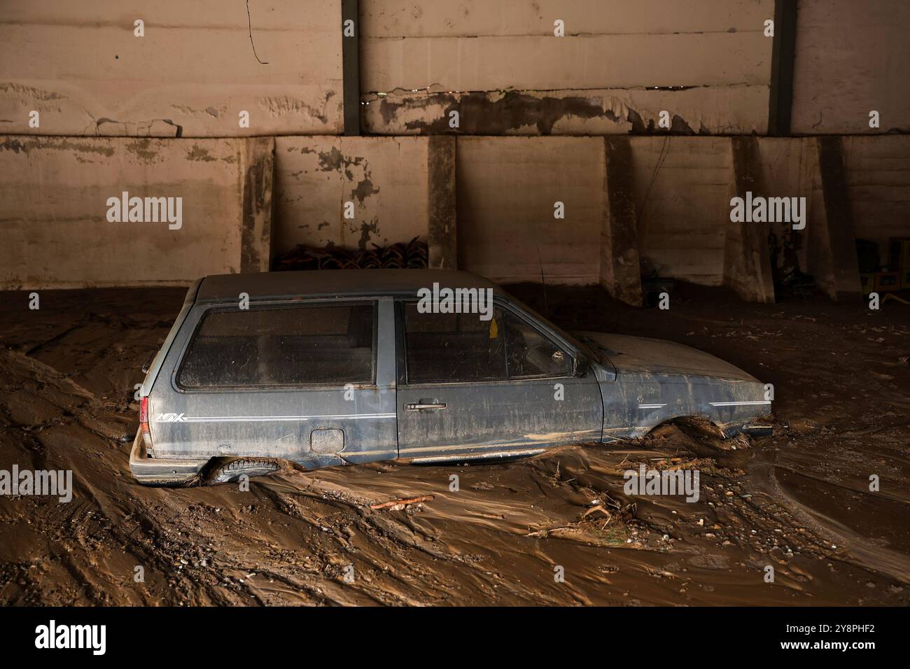 A car is submerged in mud following a flooding in Buturovic Polje ...