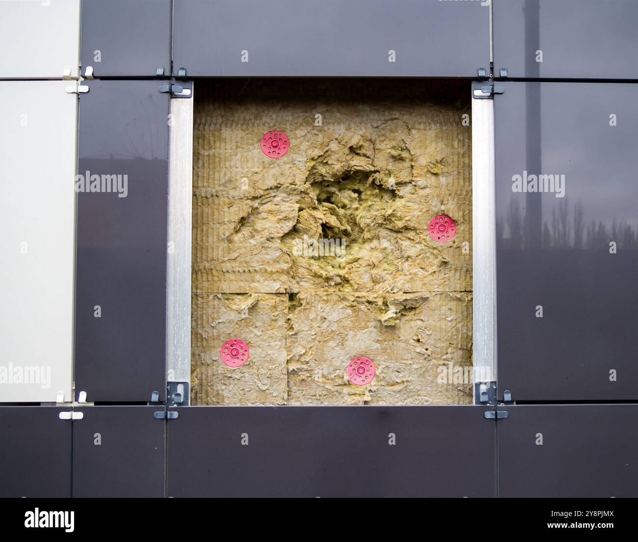 Facade with missing tiles and damaged insulation Stock Photo - Alamy