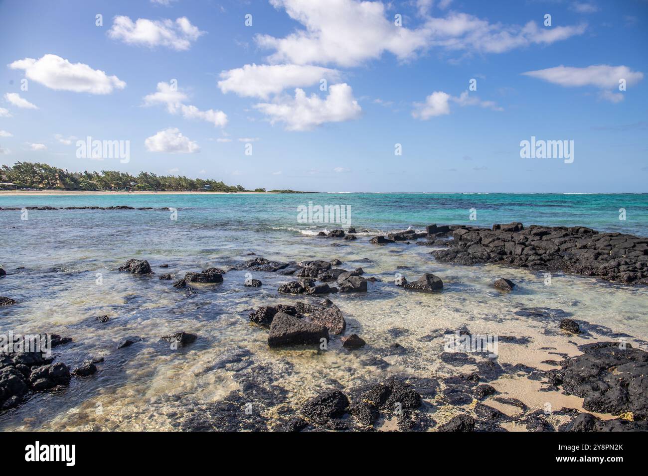 Sunrise over the sea. Sandy beach with lava rocks and beach alternate ...