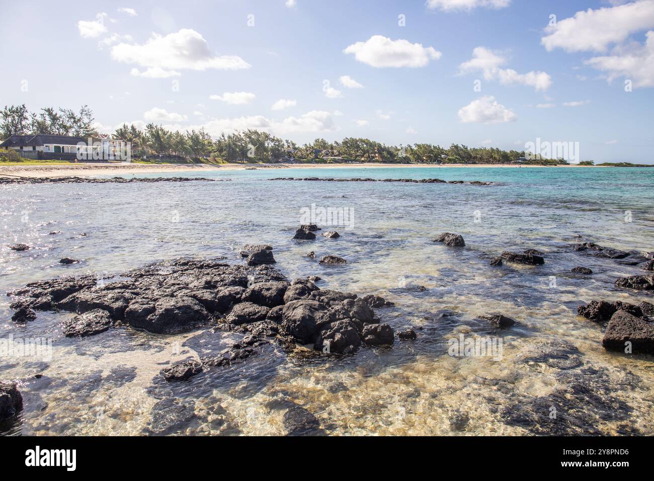 Sunrise over the sea. Sandy beach with lava rocks and beach alternate ...
