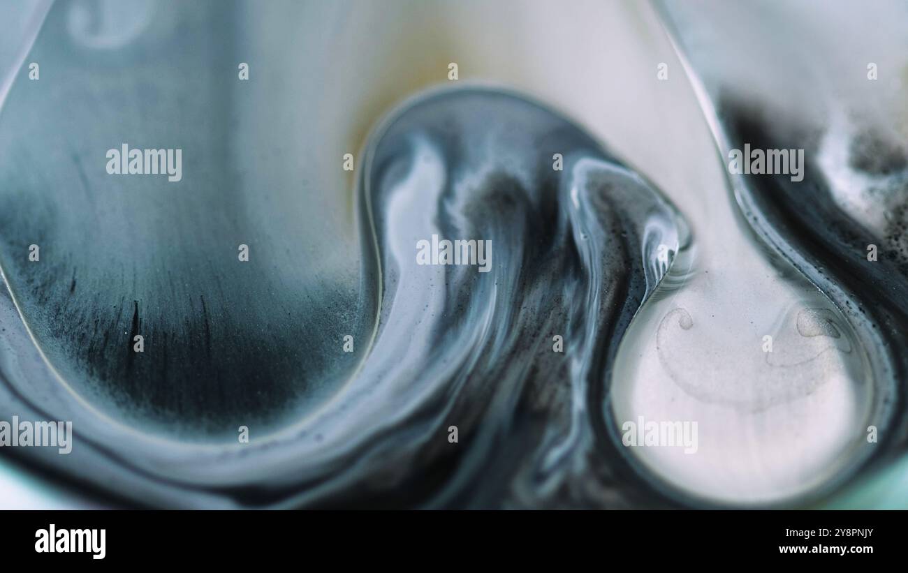 Oil fluid drop. Bubble paint spill. Defocused blue black white color ...
