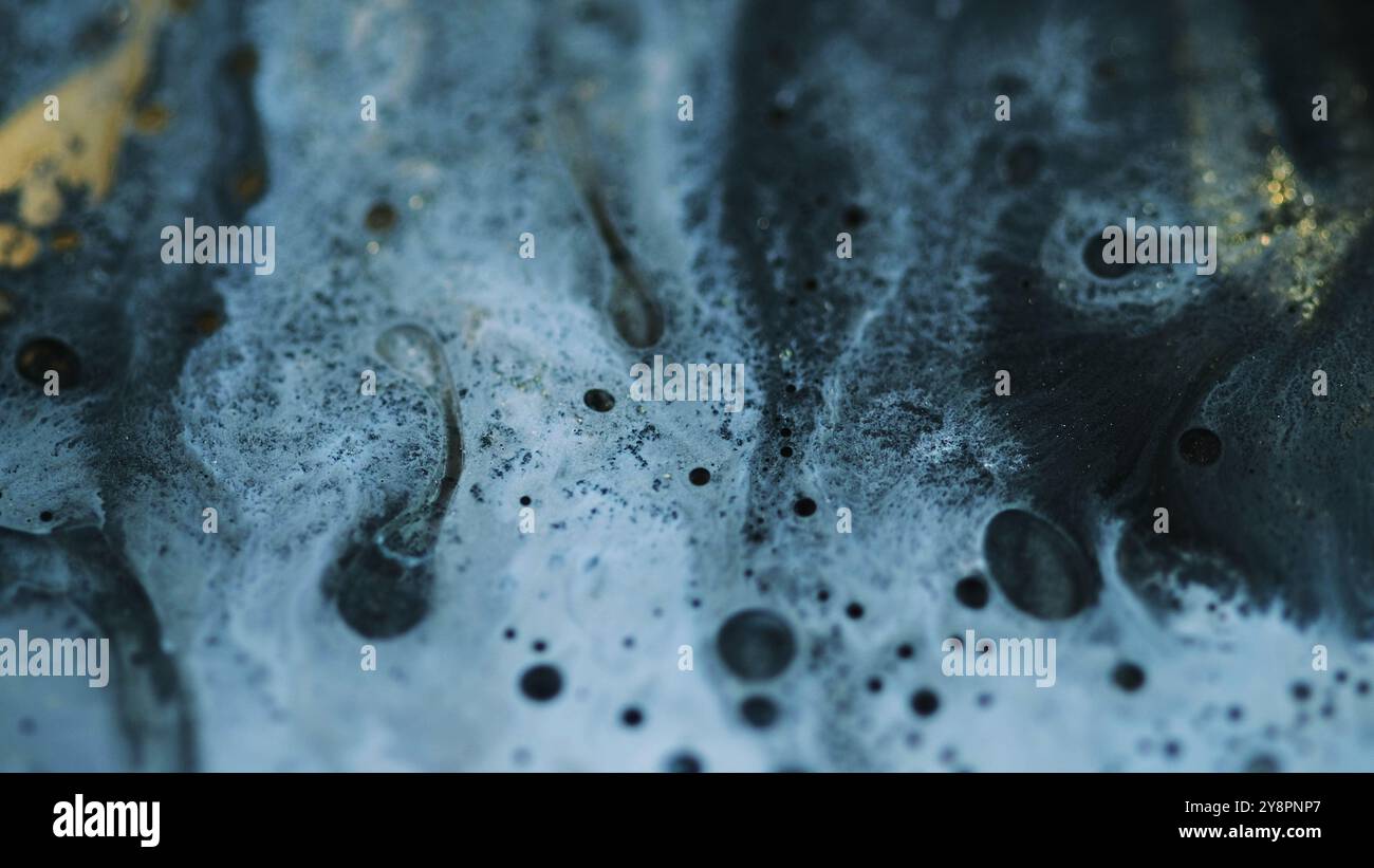 Oil ink drip. Sparkling acryl spill. Defocused blue golden color ...