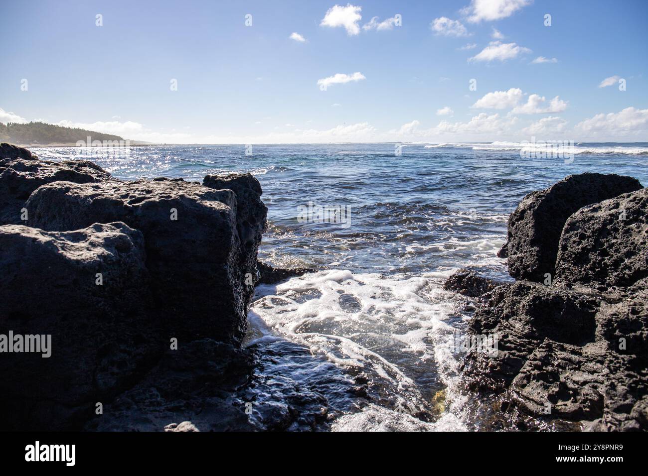 Sunrise over the sea. Sandy beach with lava rocks and beach alternate ...
