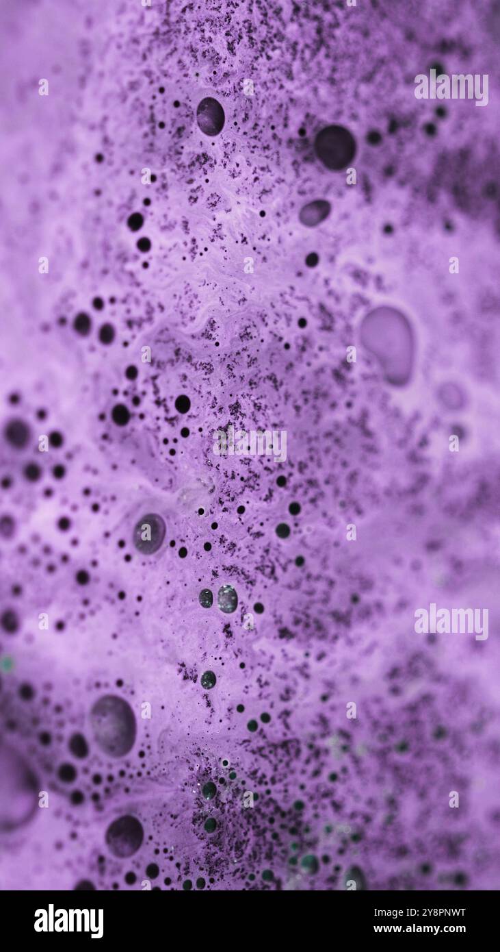 Oil ink bubbles. Sparkling emulsion. Defocused purple black color ...