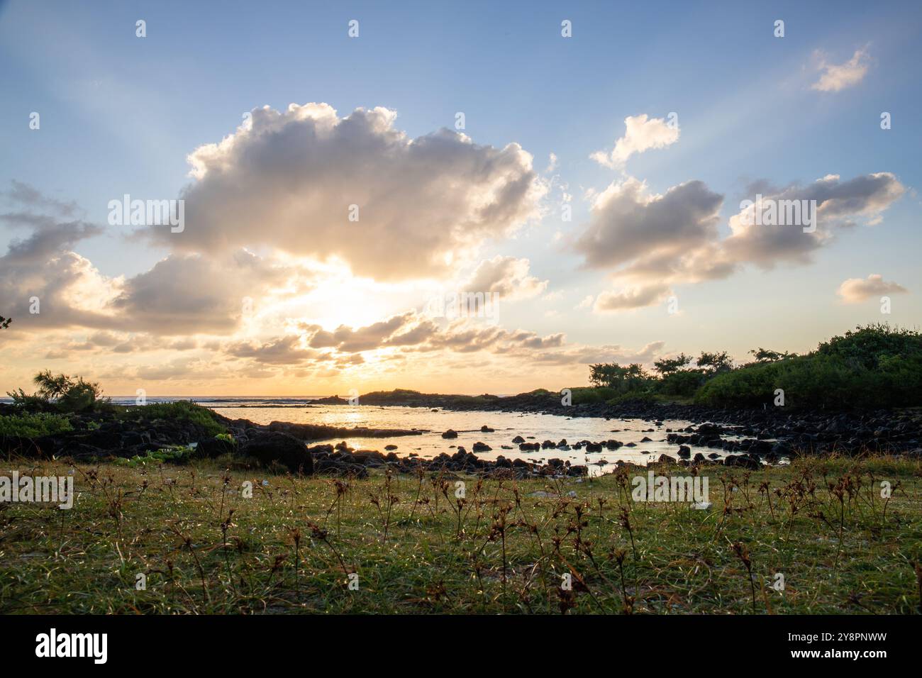 Sunrise over the sea. Sandy beach with lava rocks and beach alternate ...