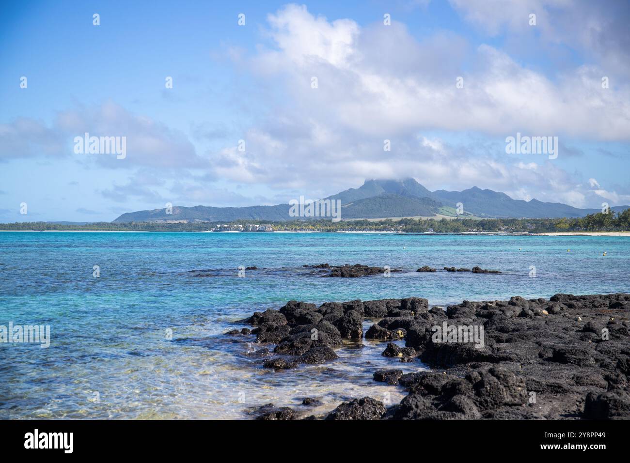 Sunrise over the sea. Sandy beach with lava rocks and beach alternate ...