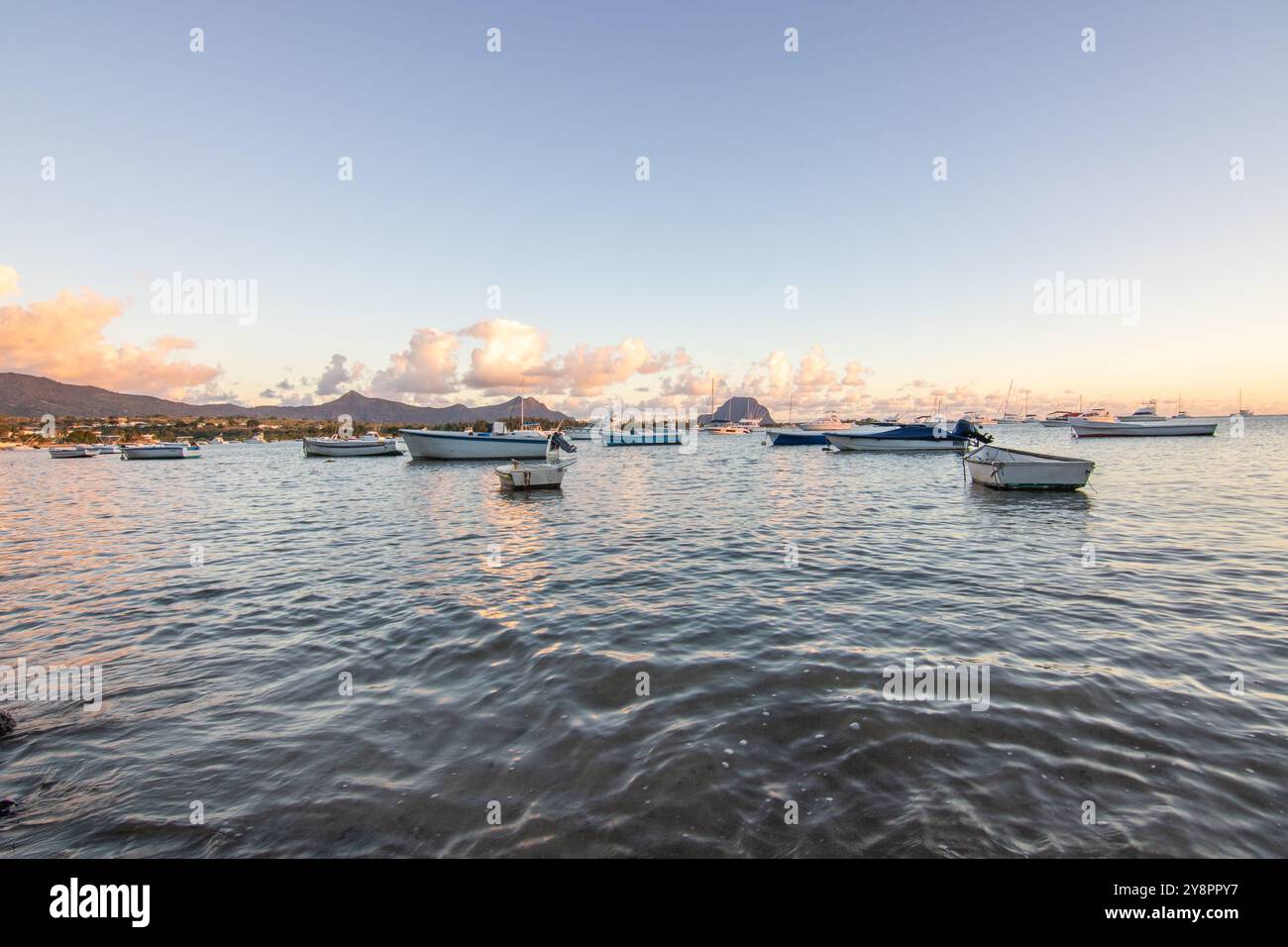 Landscape with a view over a small harbor with fishing boats. Tropical ...