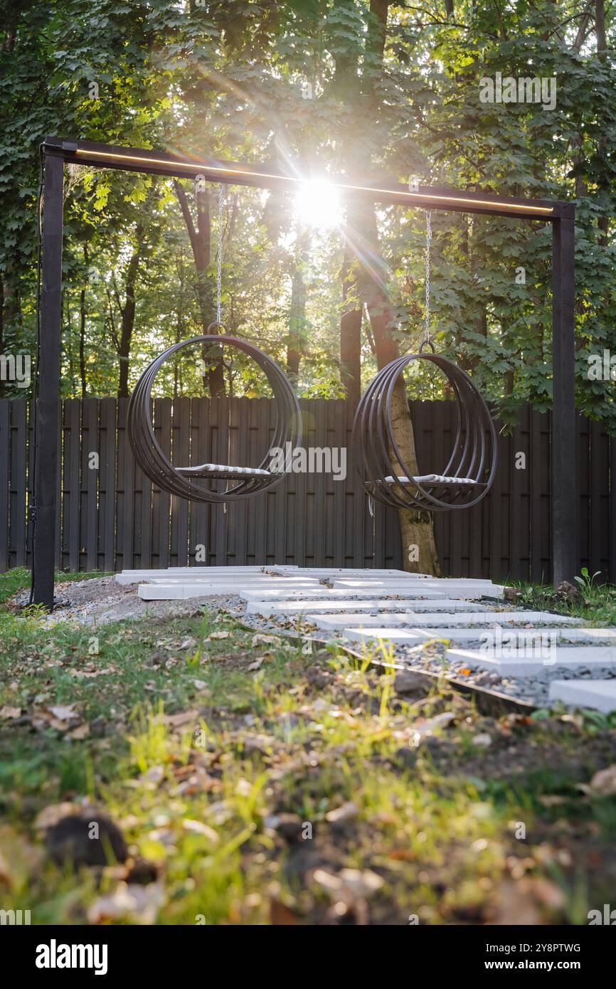 Modern hanging round swings hi-res stock photography and images - Alamy