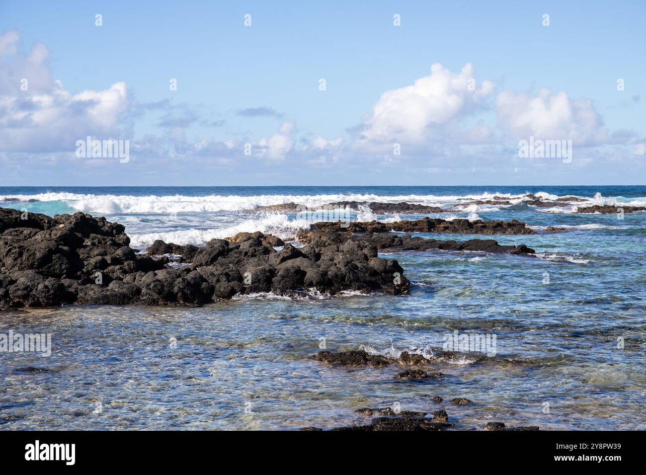 Sunrise over the sea. Sandy beach with lava rocks and beach alternate ...