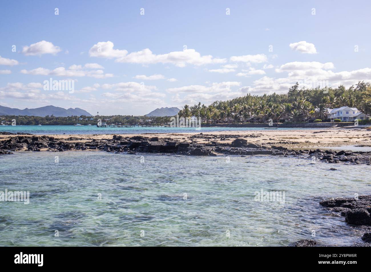 Sunrise over the sea. Sandy beach with lava rocks and beach alternate ...