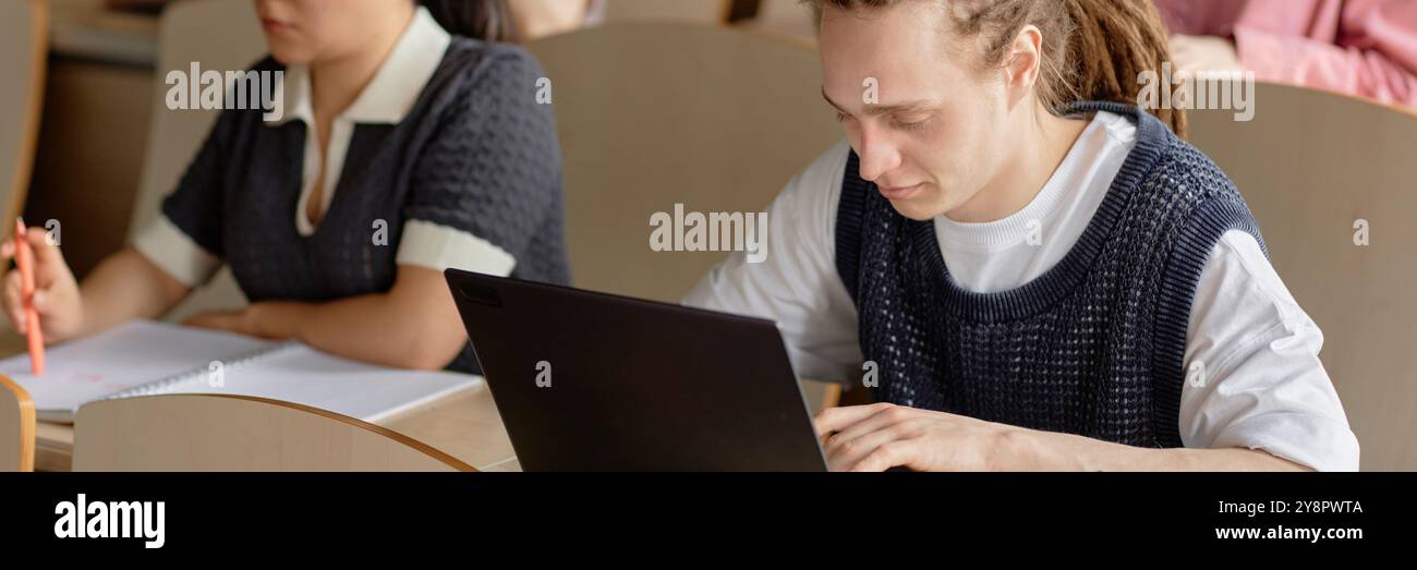 Website header image of young dreadlocked male student studying ...