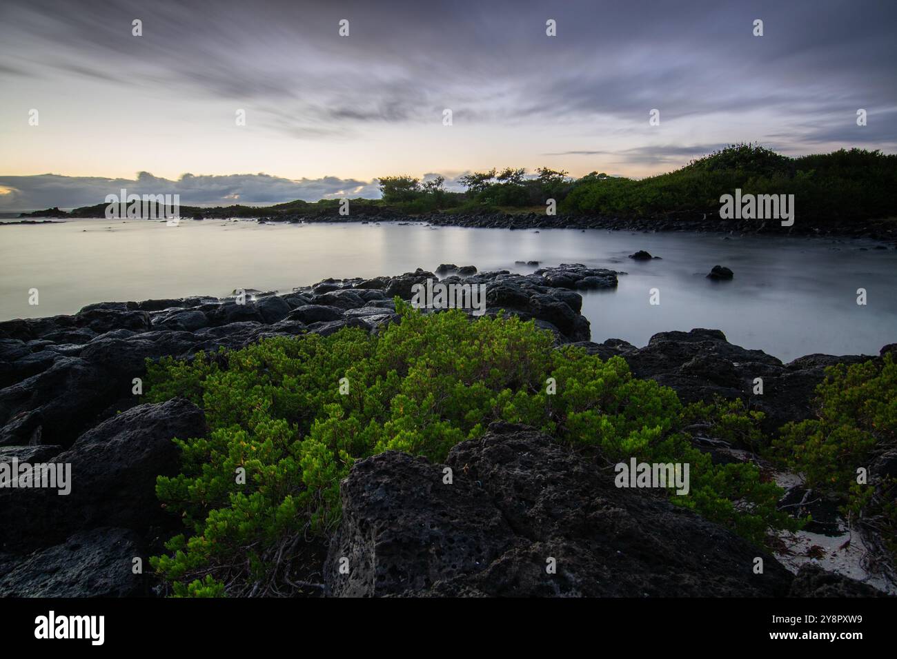 Sunrise over the sea. Sandy beach with lava rocks and beach alternate ...