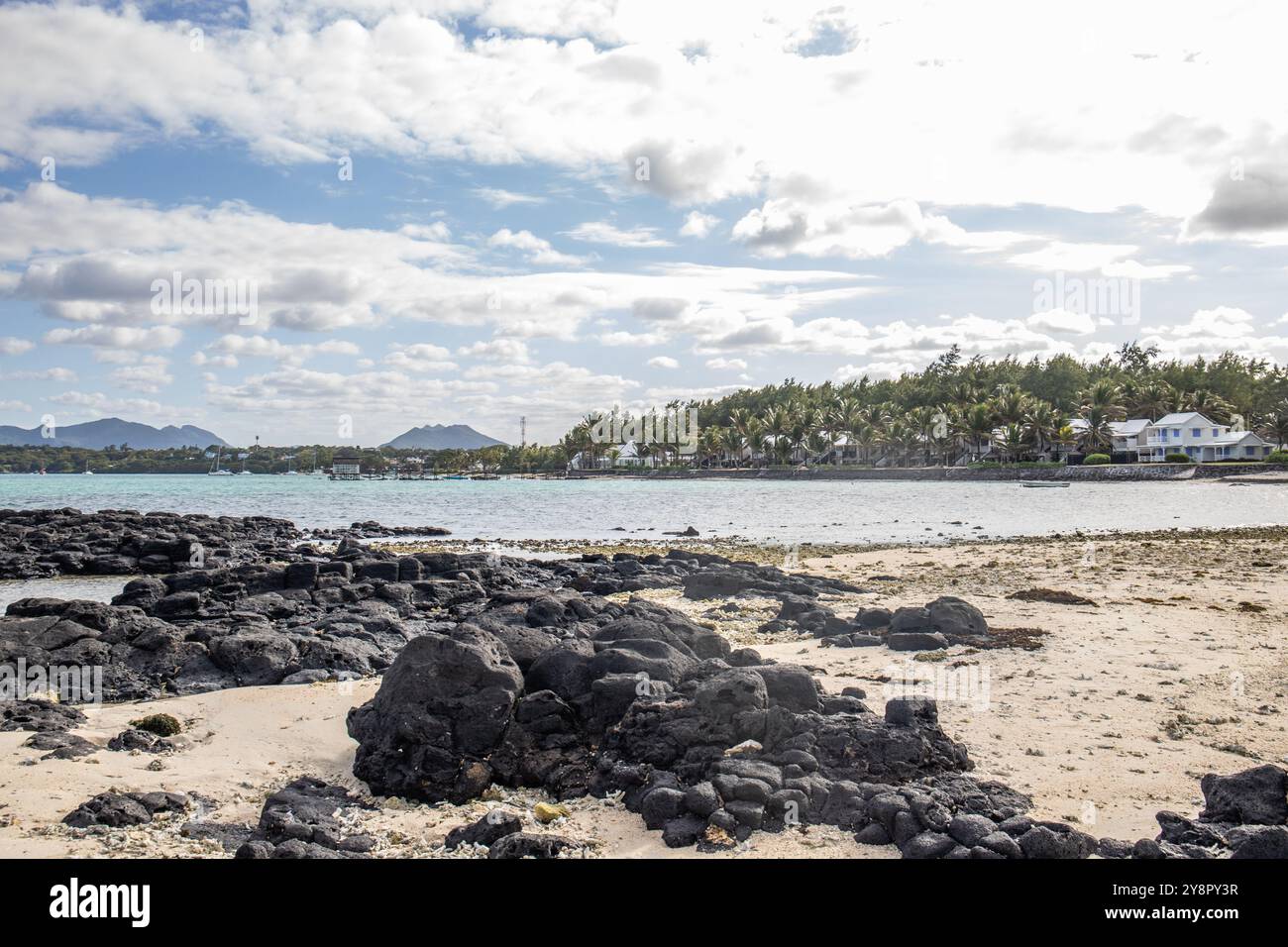 Sunrise over the sea. Sandy beach with lava rocks and beach alternate ...