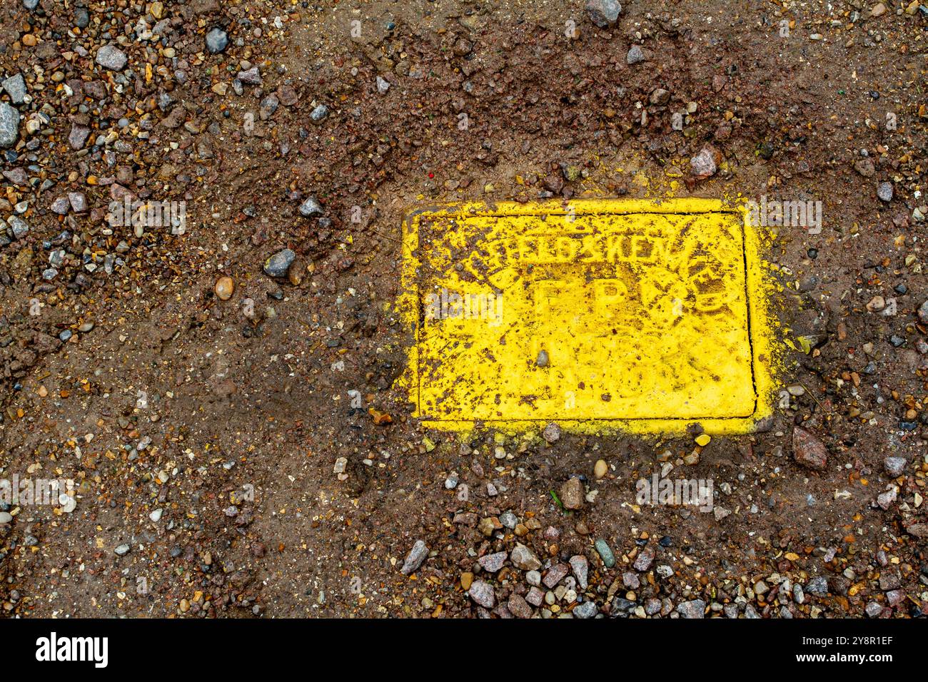 Freshly painted yellow fire hydrant surprisingly in an unmade road, it ...