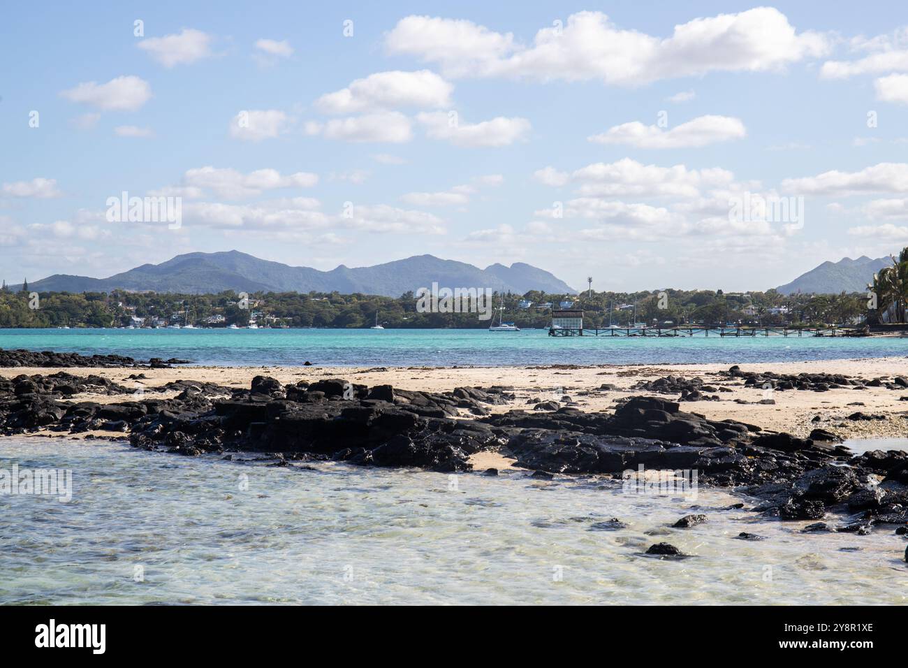 Sunrise over the sea. Sandy beach with lava rocks and beach alternate ...