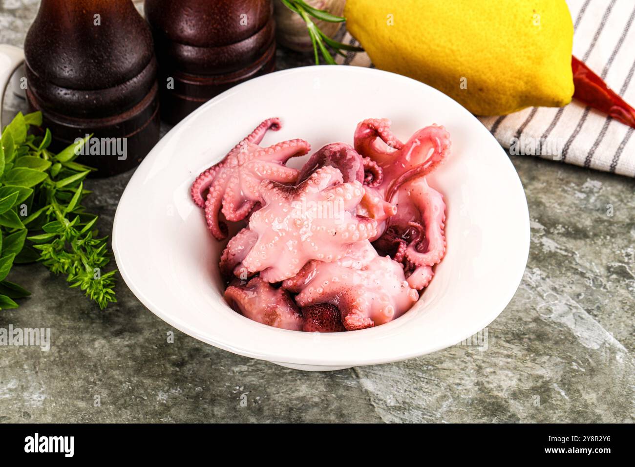 Marinated baby octopus snack appetizer served lemon Stock Photo - Alamy