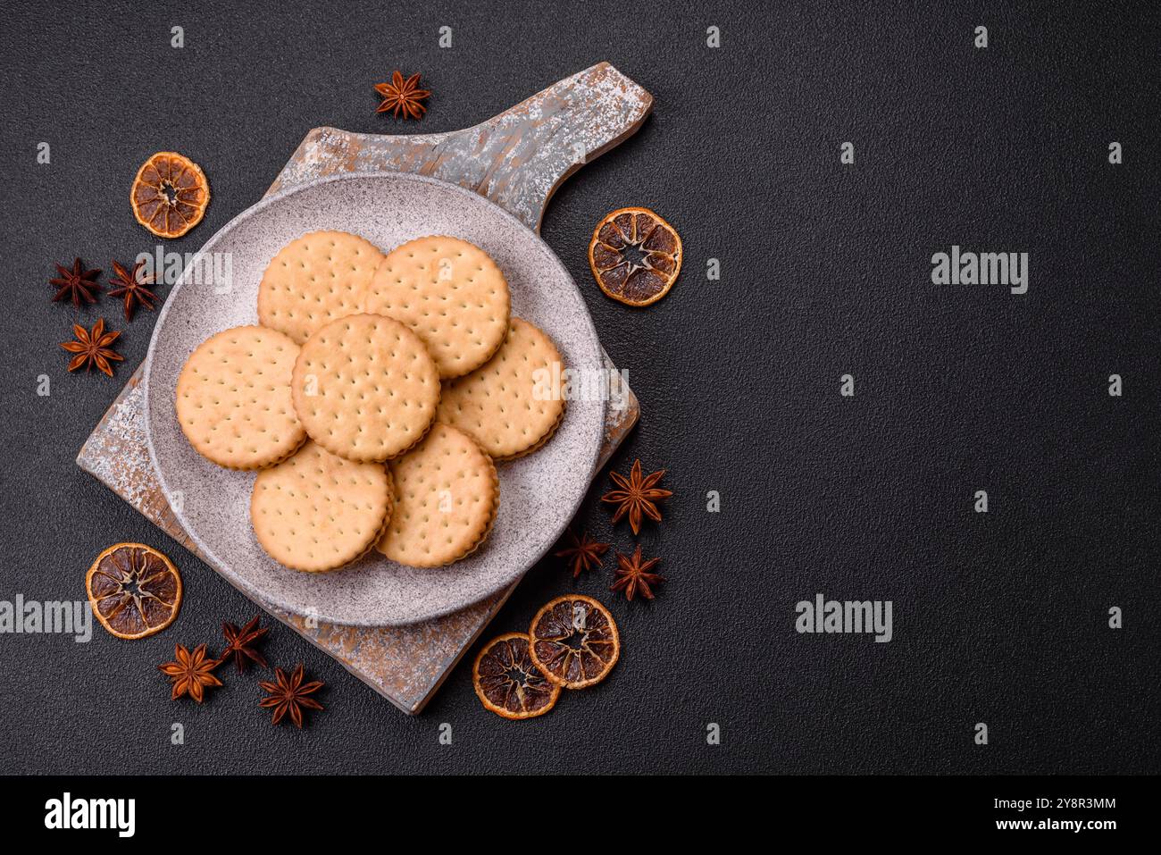 Round dotted snack snack cookies with cream on a dark concrete ...