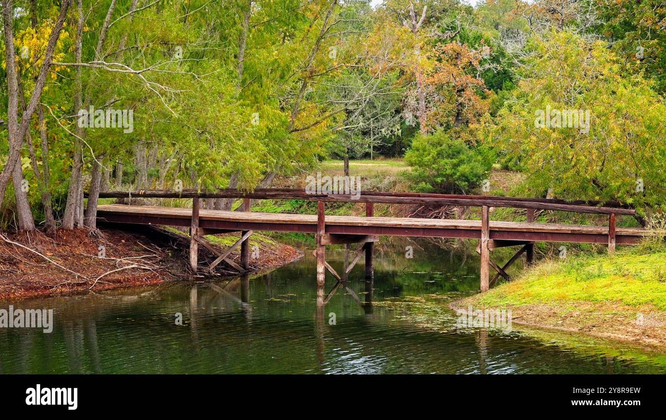 Bridge to Island over part of a lake Stock Photo - Alamy