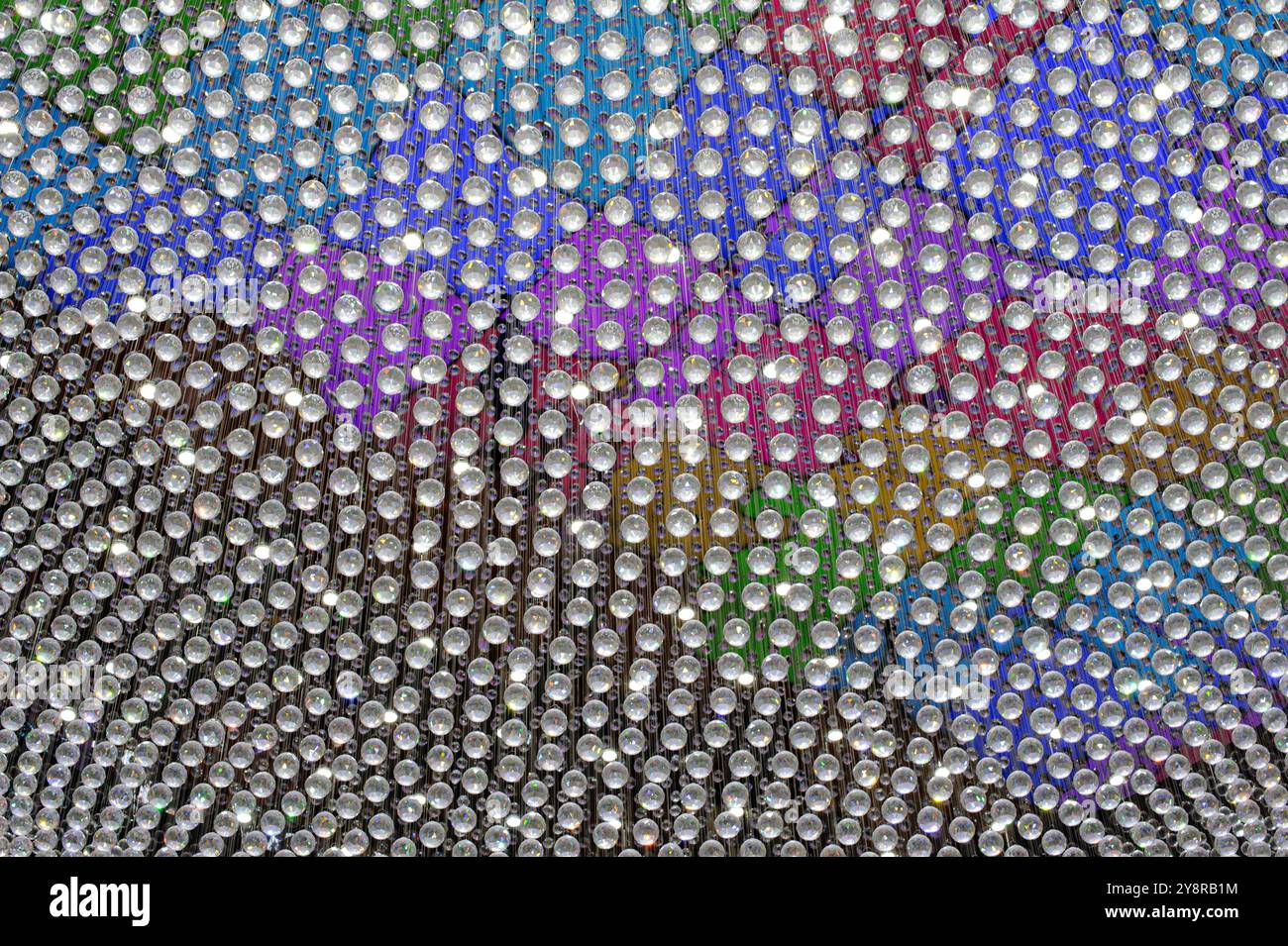 Abstract photograph of dozens of tiny, colorless, plastic balls set ...