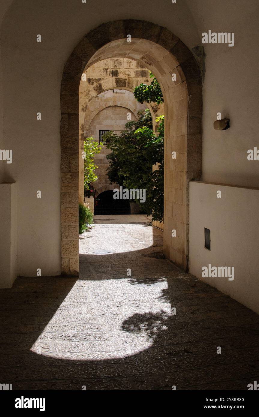 Classic stone arch entrance to a courtyard in the Jewish Quarter of the ...