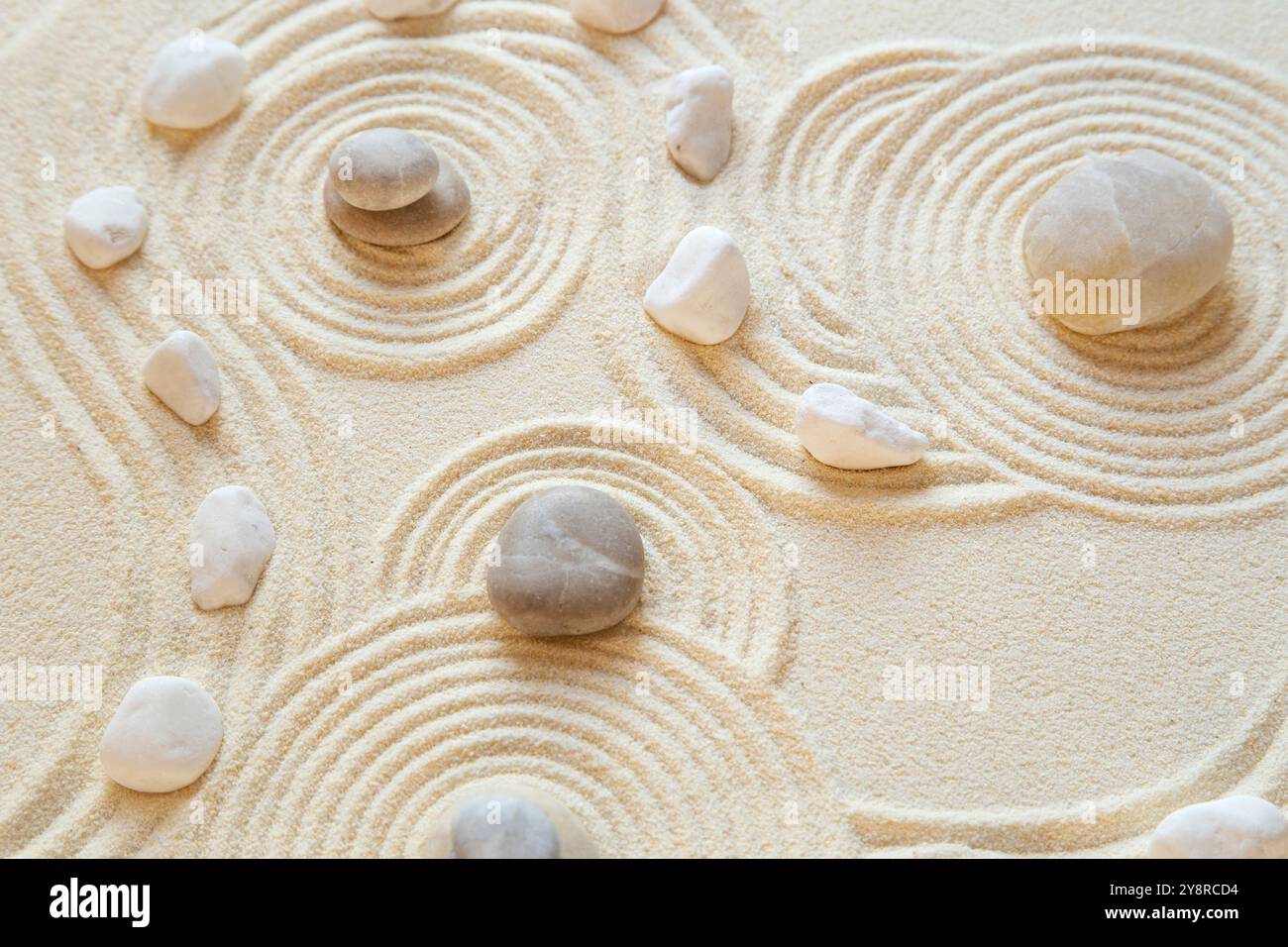 Zen garden with a sand pattern and stones Stock Photo - Alamy