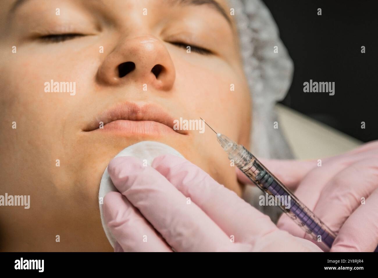 contour plastic. A cosmetologist injects a botulinum toxin to tighten ...