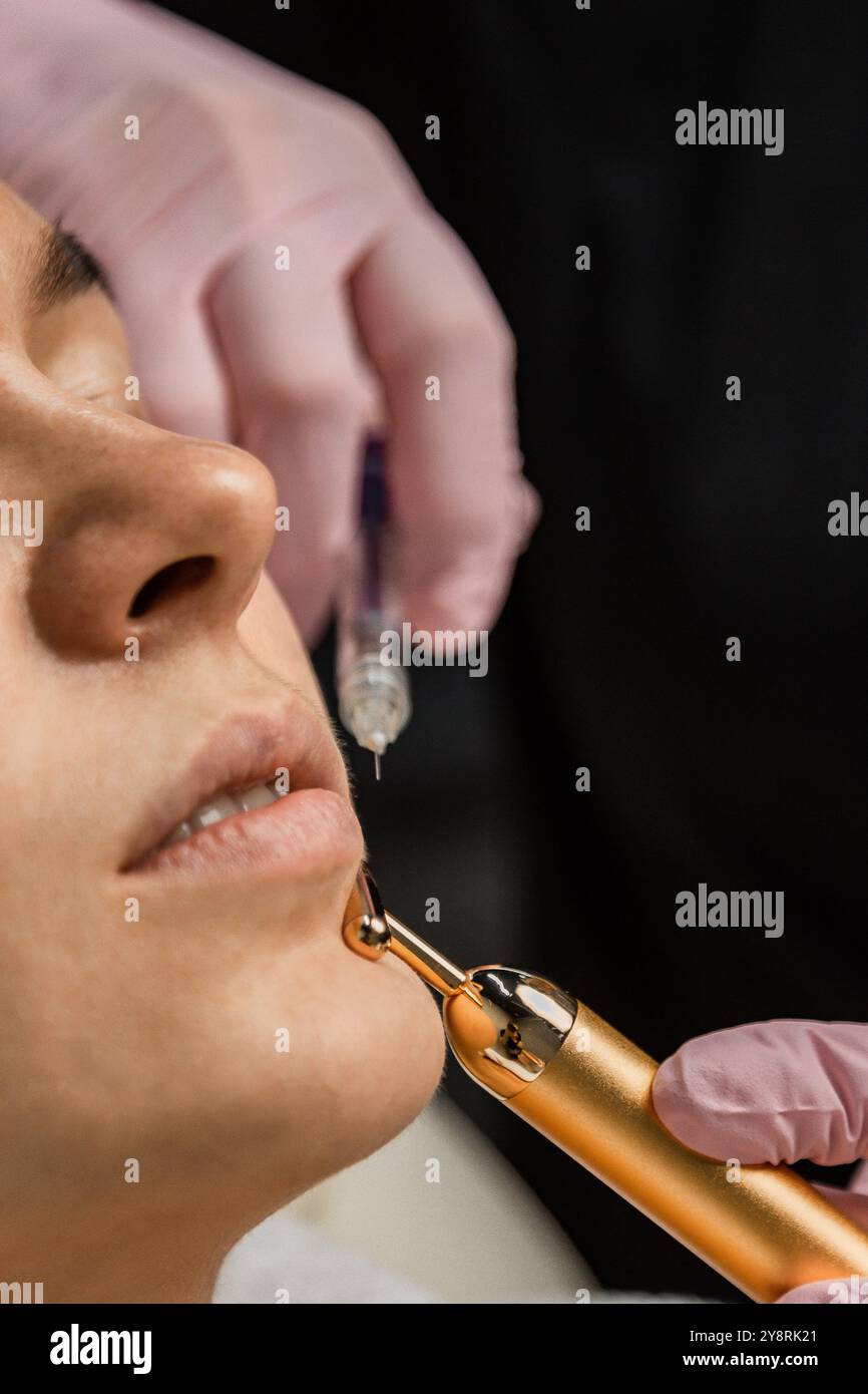 contour plastic. A cosmetologist injects a botulinum toxin to tighten ...