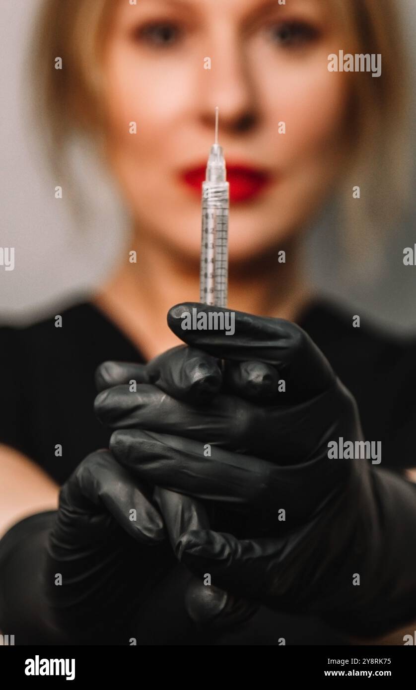 contour plastic. A cosmetologist injects a botulinum toxin to tighten ...