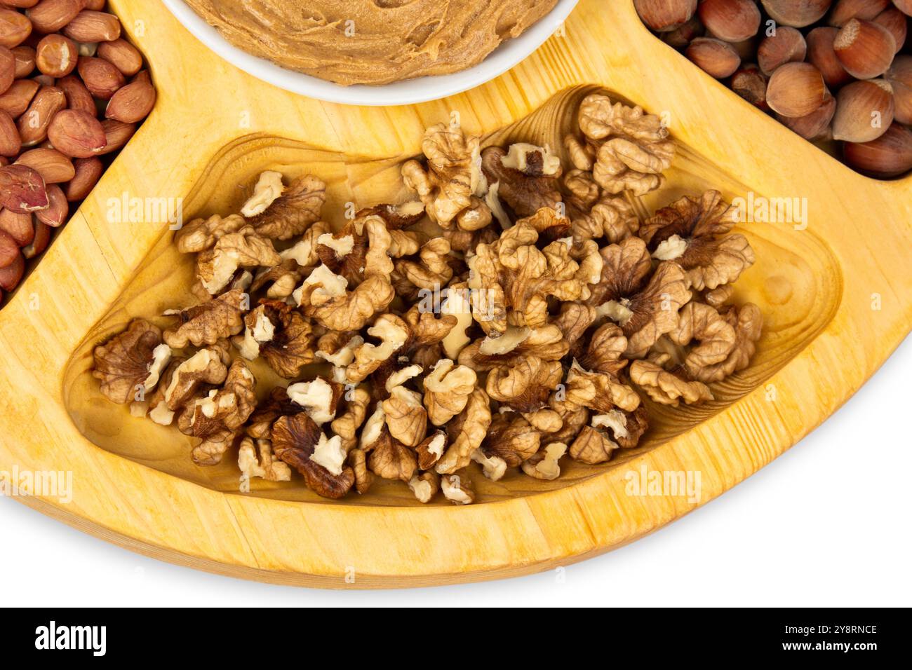 Peanuts, walnuts and hazelnuts in a wooden box with compartments. Three ...
