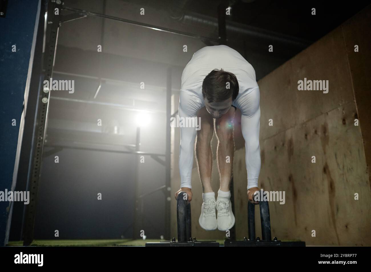 Low angle shot of professional male athlete taking off to press into ...