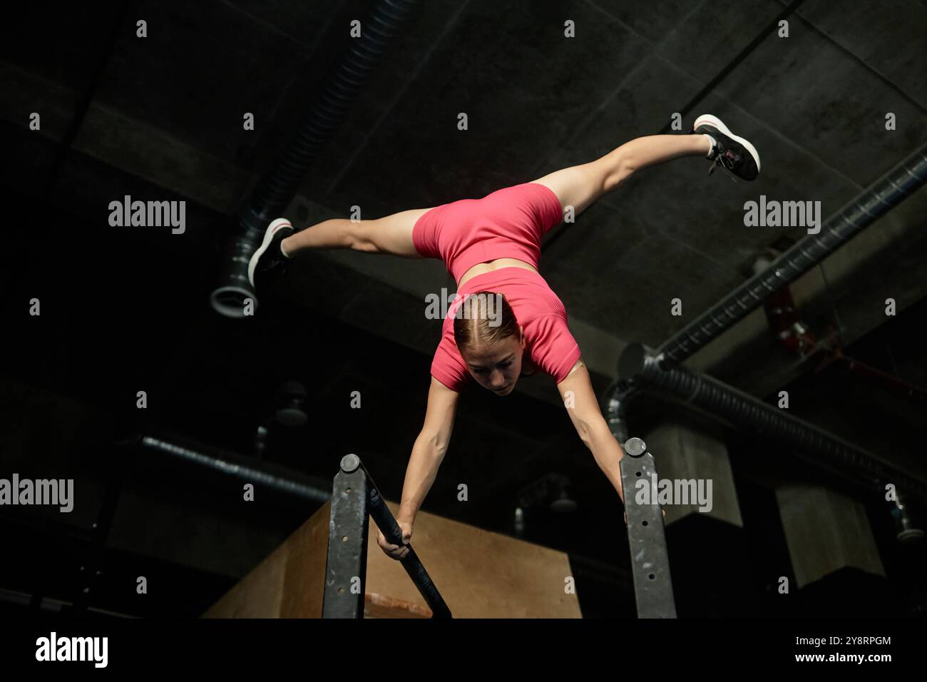 Low angle shot of professional female athlete balancing in handstand on ...