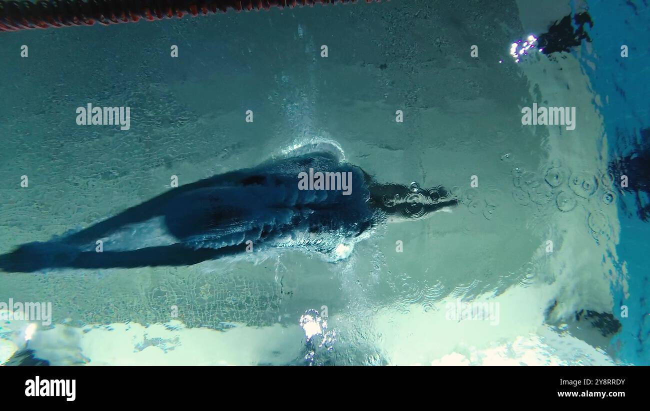 sportswoman swimmer in a tracksuit, in diving goggles, in a swimming ...