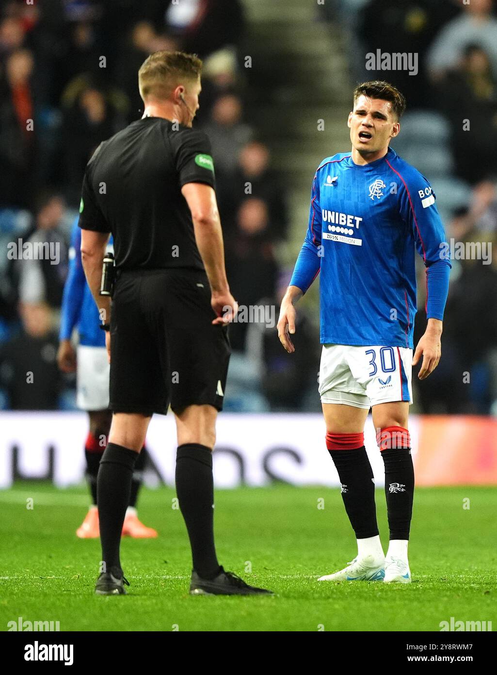 Rangers' Ianis Hagi (right) reacts after being shown a yellow card by ...