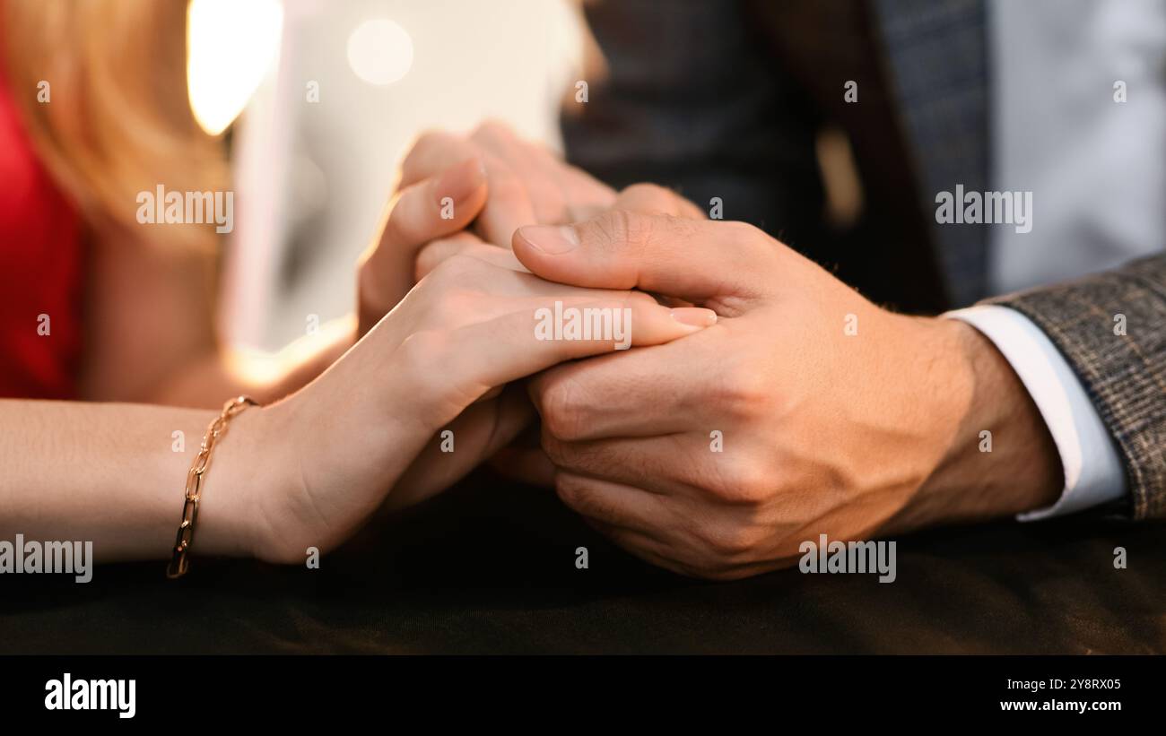 Closeup Of Romantic Couple Holding Hands On Date Dinner In Restaurant ...