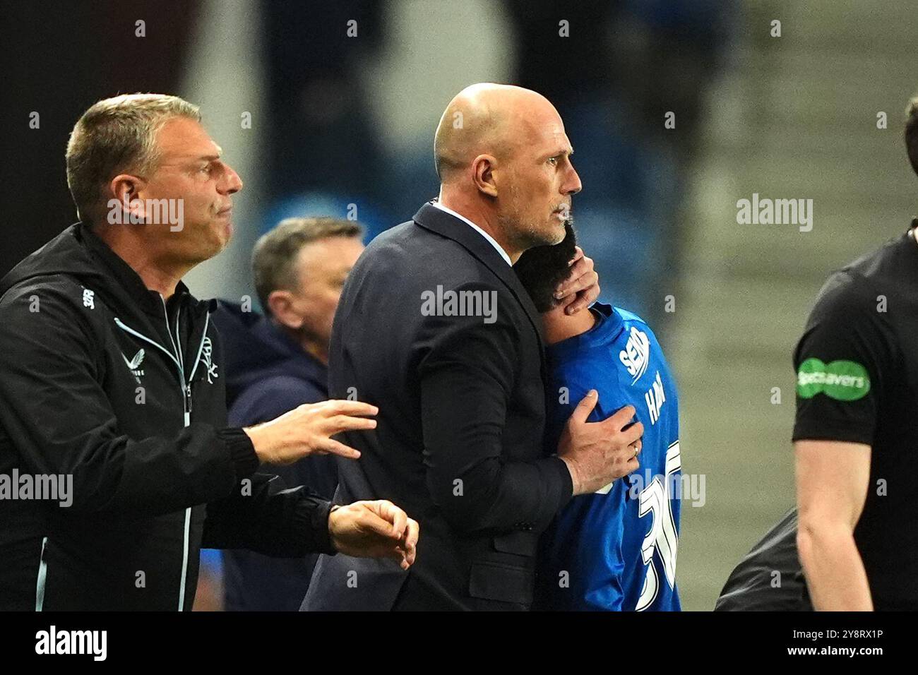 Rangers' Ianis Hagi (right) is consoled by manager Philippe Clement ...
