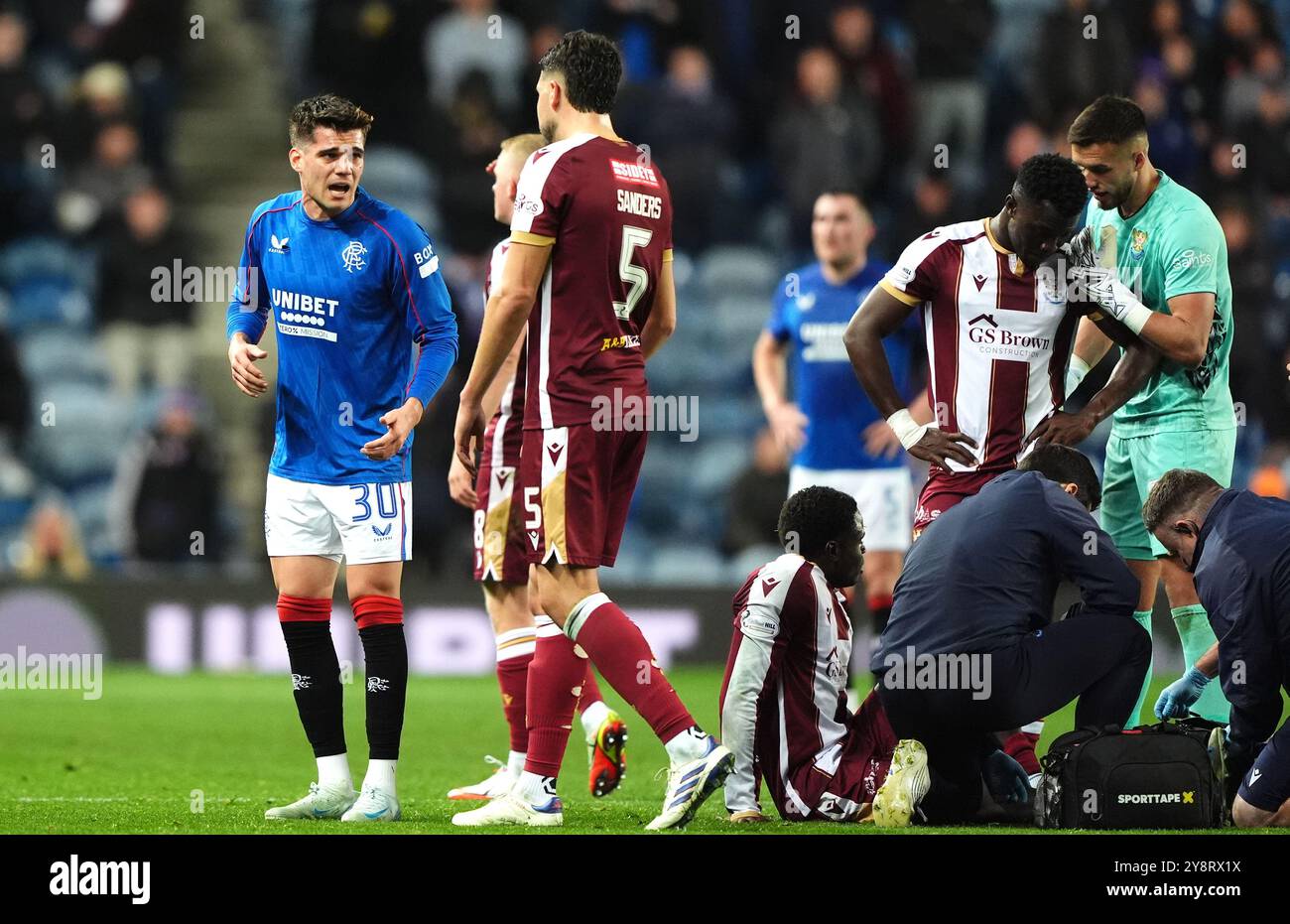 Rangers' Ianis Hagi (left) reacts after being shown a yellow card by ...