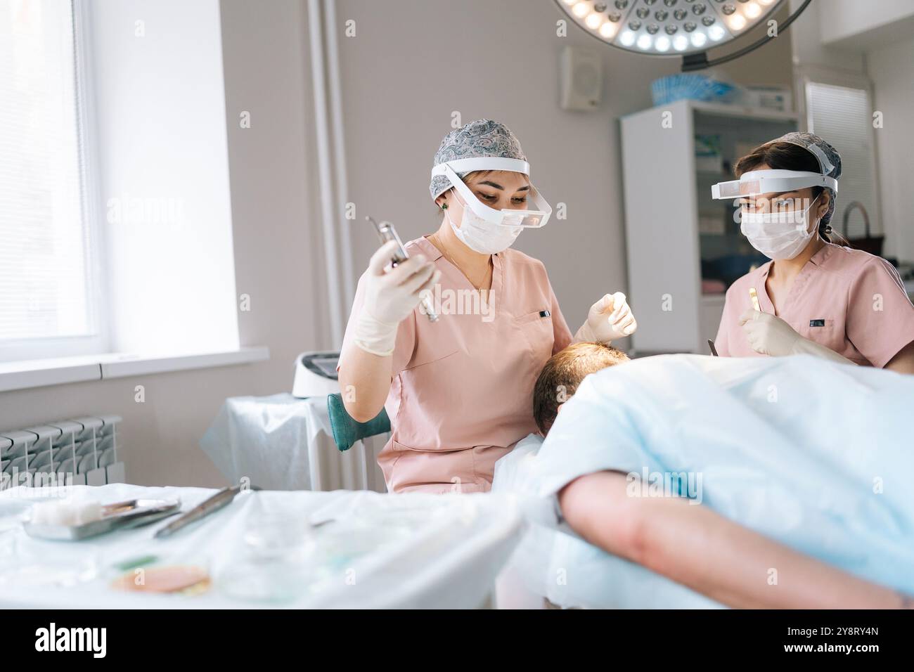 Medium shot of two female trichologist performing local needle-free ...