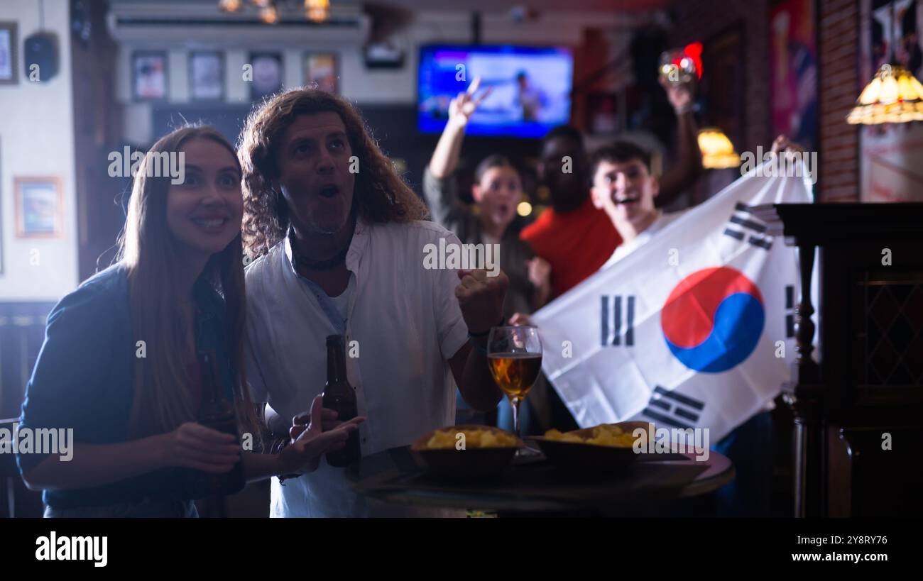 Excited couple of football fans cheering for team of South Korea in ...