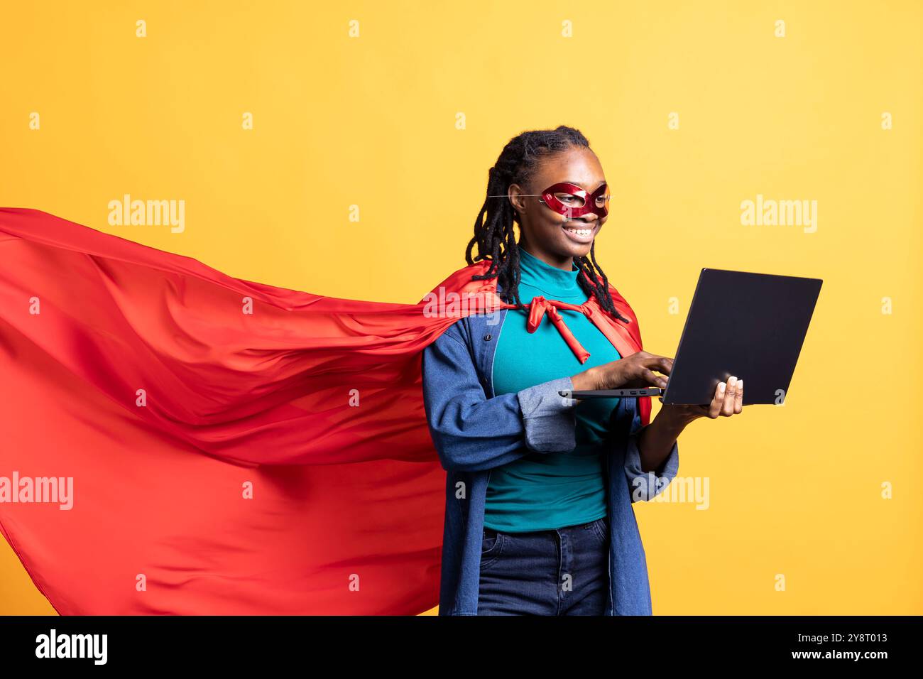 Happy young girl wearing superhero costume and mask for Halloween ...