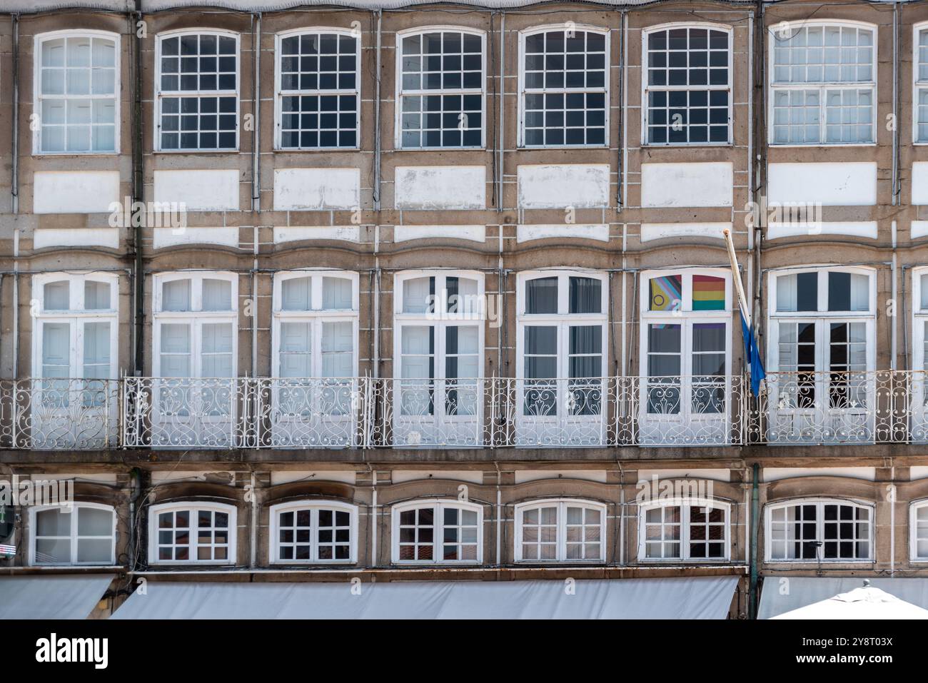 Traditional Portuguese facade with many windows at a house at Largo do ...